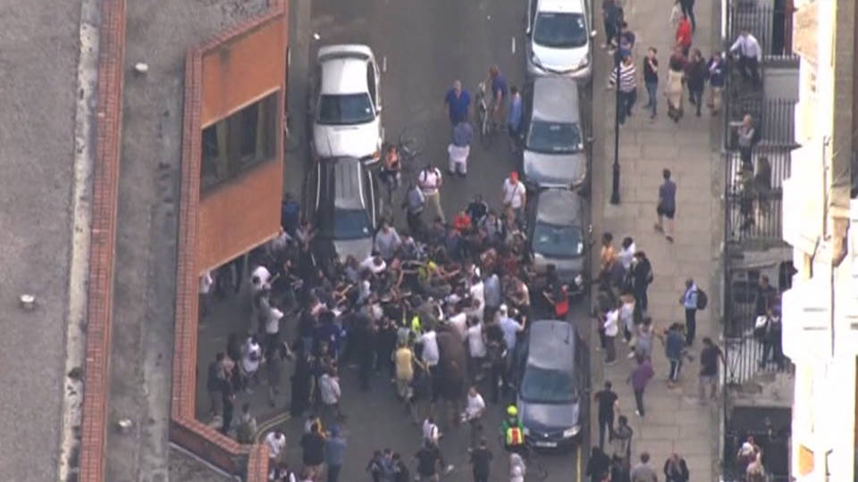 Hundreds of protesters stormed a town hall in London Friday, demanding ...